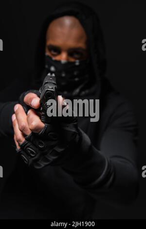 African american bandit with scarf on face looking away isolated on ...