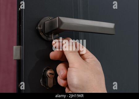 Hex key and installation of door lock and handle, close-up installation ...
