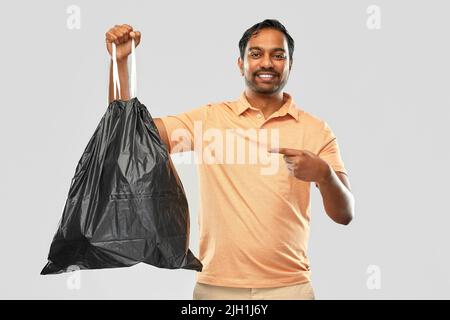 smiling indian man holding trash bag Stock Photo - Alamy