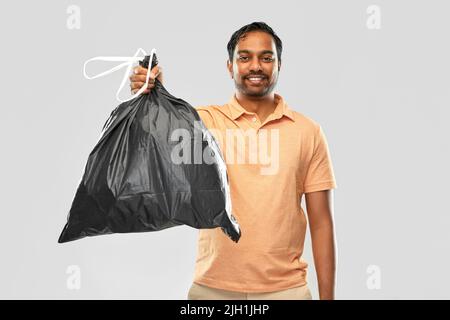 smiling indian man holding trash bag Stock Photo - Alamy