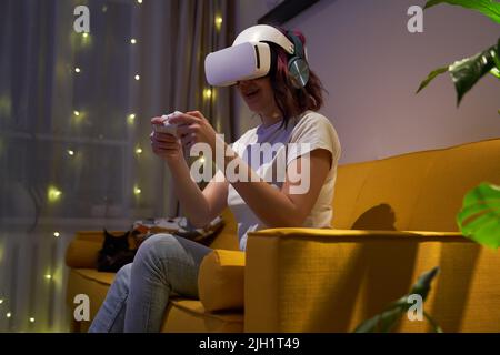 Woman with virtual reality headset and joystic is playing game. Concept ...