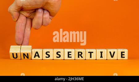 Assertive or unassertive symbol. Businessman turns wooden cubes and ...