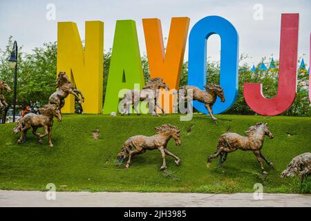 Monumental colored letters and horse stampede sculpture at the entrance ...