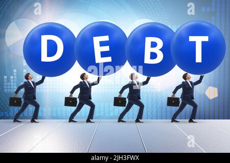 Businessmen in the load and debt concept Stock Photo - Alamy