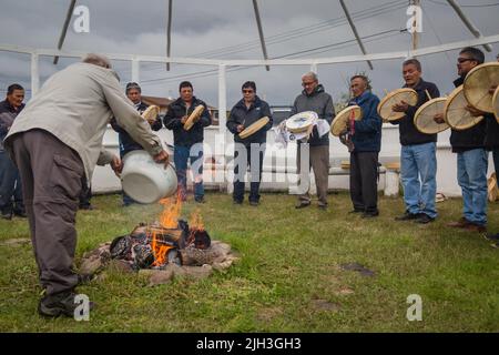 Indigenous Dene men at fire feeding ceremony, in the northern community ...