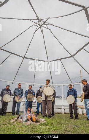 Indigenous Dene men at traditional fire feeding ceremony, in the ...