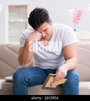 Young man in sad saint valentine concept Stock Photo - Alamy