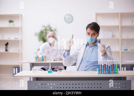 Two chemists working at the lab during pandemic Stock Photo - Alamy