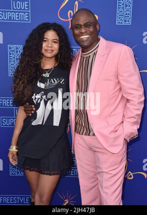 Maile Masako Brady and Wayne Brady walking on the red carpet at the ...