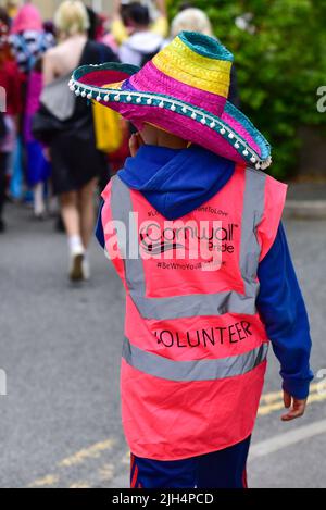 A young volunteer steward in the vibrant colourful Cornwall Prides ...
