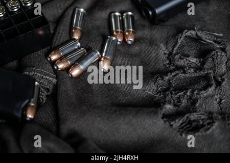 9mm conceal semi automatic gun with jacket hallow point bullet on cloth ...