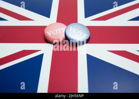Vote badges on a Great Britain union jack flag. Election background ...