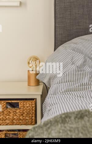 Comfortable bed and chairs located in near wall with framed painting in ...