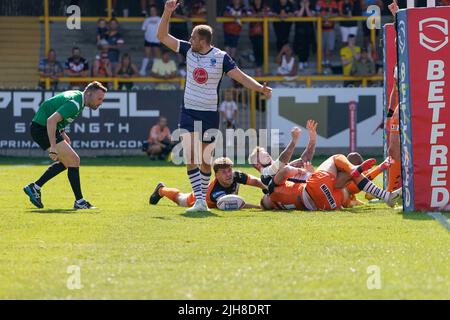 Daryl Clark #9 of Warrington Wolves stretches over the line to score a ...