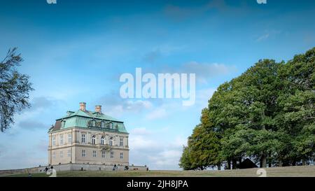 A beautiful view of Hermitage Palace at dyrehaven deer park in Denmark ...