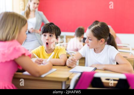 Tweens working in small groups during lesson at school Stock Photo - Alamy