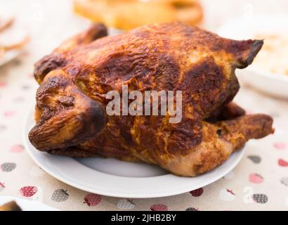ruddy chicken fried whole on a plate on the festive table Stock Photo ...