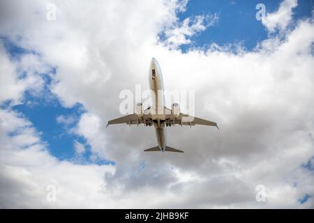 A low angle view of a TUI aircraft landing in stormy weather and ...