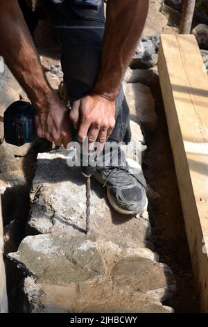 Construction worker Using an electric jackhammer to drill perforator ...