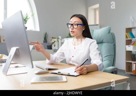 Asian women doctor online consultation telemedicine video call using ...