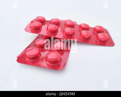 medecine red tablets isolated on white backgroun Stock Photo - Alamy