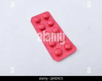 medecine red tablets isolated on white backgroun Stock Photo - Alamy