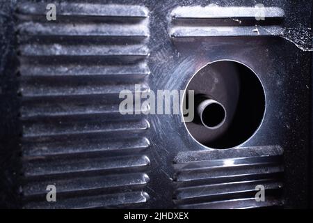 Exhaust pipe of a gasoline generator close-up with red illumination ...