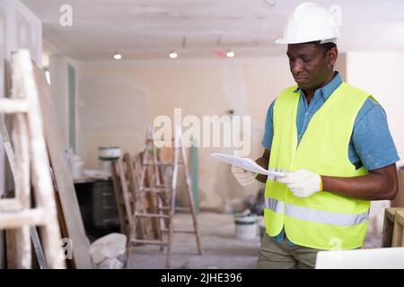 African american foreman examines documents and plans a workflow for ...