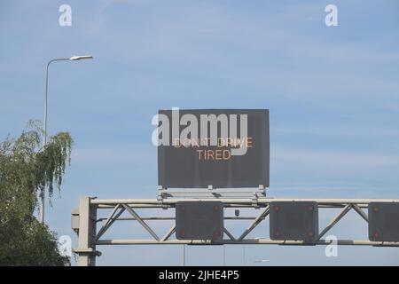 A smart motorway signs stating the national speed limit is restricted ...