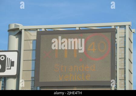 A smart motorway signs stating the national speed limit is restricted ...
