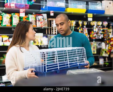 Couple shopping for cage for small animal Stock Photo - Alamy