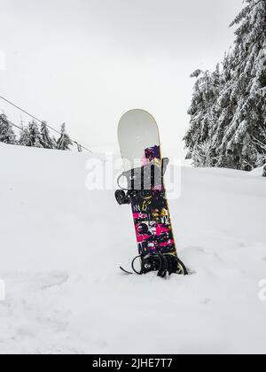 snowboard stick out from the snow ski resort Stock Photo - Alamy