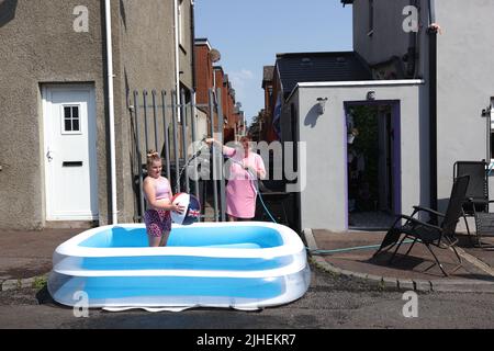 Danielle Lofthouse cools down her daughter Amelia Bradford, 10, with a ...