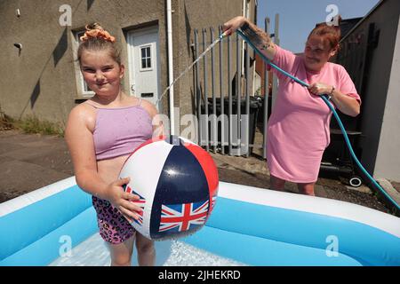 Danielle Lofthouse cools down her daughter Amelia Bradford, 10, with a ...