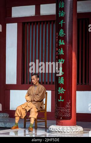 Buddhist monk, sitting on a chair in a temple Stock Photo - Alamy