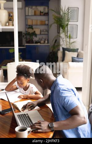 Dad and daughter doing homework together at home Stock Photo - Alamy