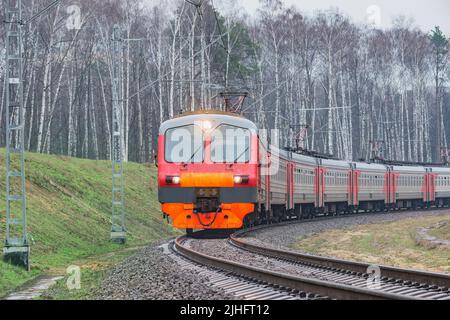 Passenger train moves at spring morning time Stock Photo - Alamy