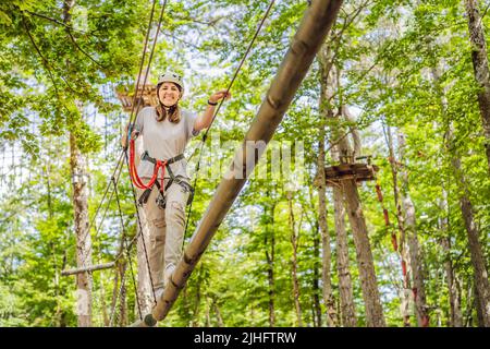 Happy women girl female gliding climbing in extreme road trolley ...