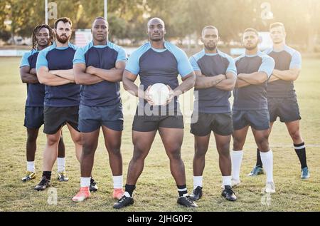 Portrait of confident players with rugby ball Stock Photo - Alamy