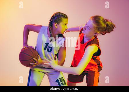 Attack and defense. Female basketball players, young girls, teen in ...