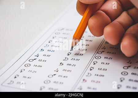 Modern astrologer's desktop. Hand with a pencil. Astrological charts ...