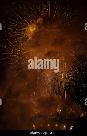 Fireworks exploding behind the smoke against black background Stock ...