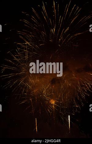 Fireworks exploding behind the smoke against black background Stock ...