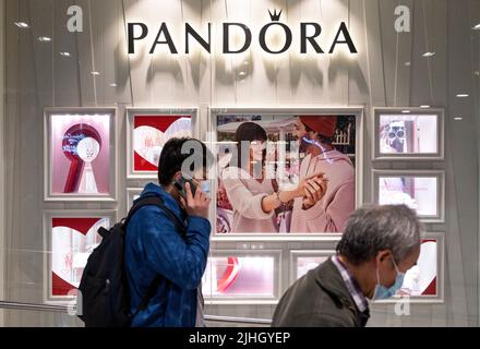 Shoppers walk past the Danish jewelry manufacturer and retailer ...