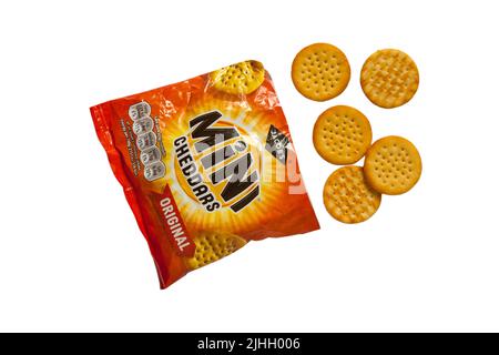 Open bag of Jacobs Mini Cheddars with biscuits spilling out on white ...