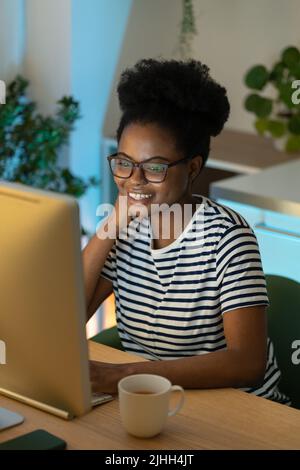 Successful woman programmer working in a stylish office behind a laptop ...