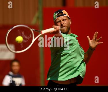 French tennis player Hugo Grenier hits a forehand in his match versus ...