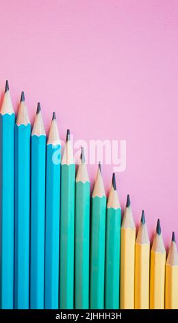 Colored wooden pencils on pink background, education concept Stock ...