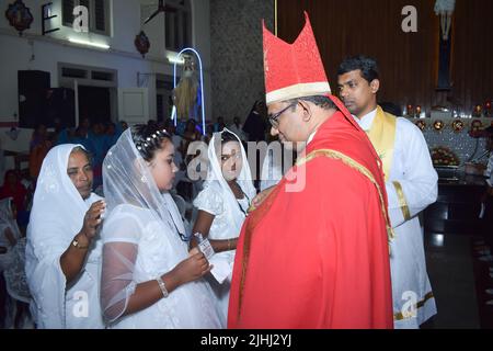 Catholic bishop is giving Confirmation sacrament Stock Photo - Alamy