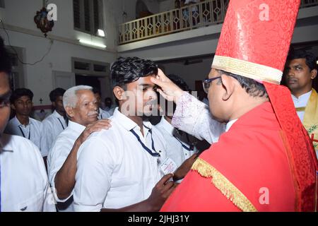 Catholic bishop is giving Confirmation sacrament Stock Photo - Alamy